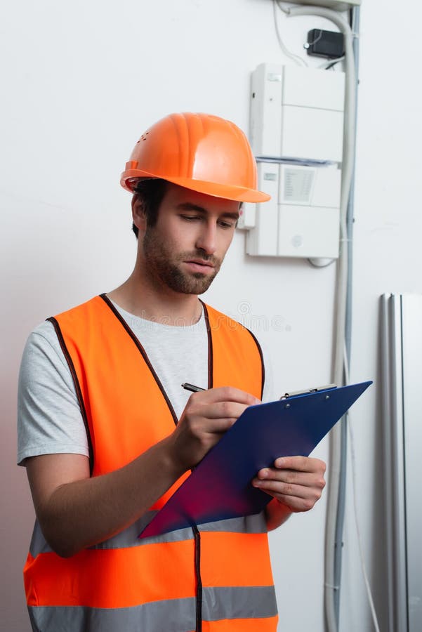 Workman in Safety Vest Writing on Stock Image - Image of workman, write ...