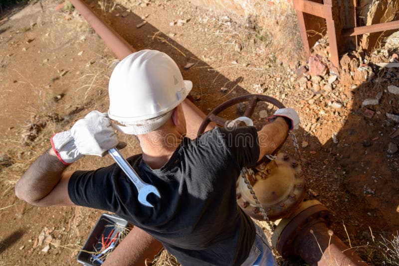 Workman Shunting a valve stock image. Image of plumbing - 78455627