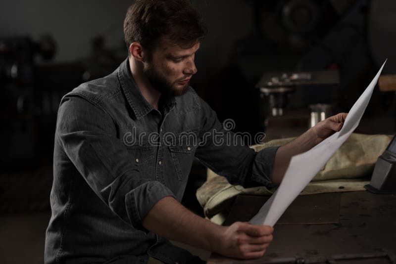 Workman Sitting at Table and Looking Stock Photo - Image of caucasian ...