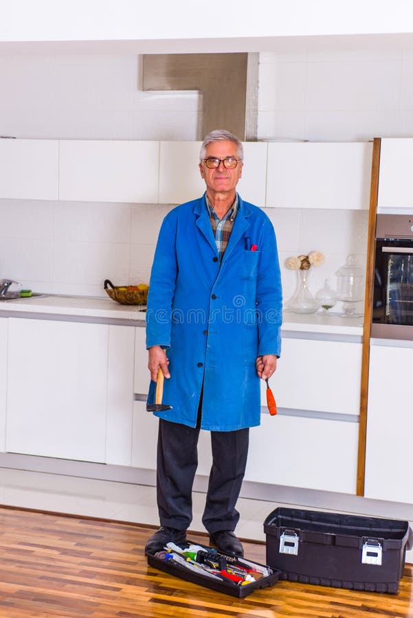 Uniform Handyman Working in the Kitchen Stock Image - Image of fixing ...