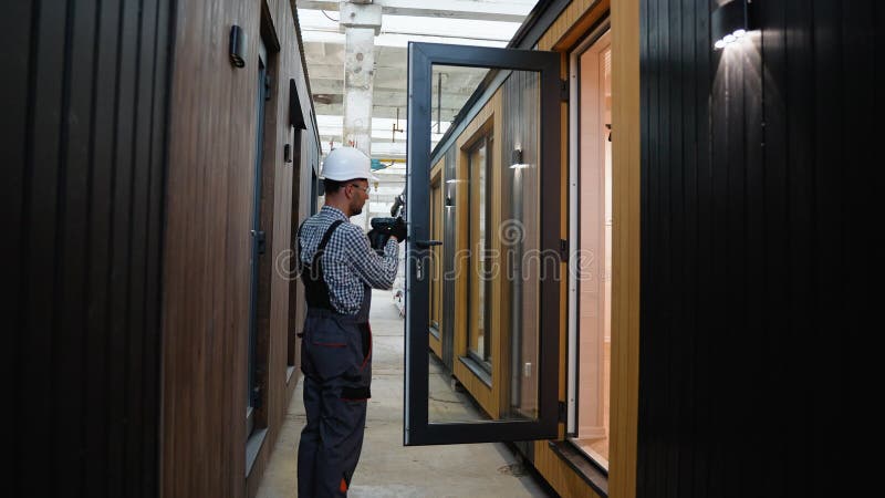 Workman in Uniform Installing Plastic Windows in Prefabricated Modular ...