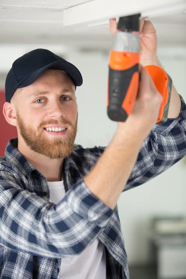 Workman Using Cordless Screwdriver on Ceiling Stock Image - Image of ...