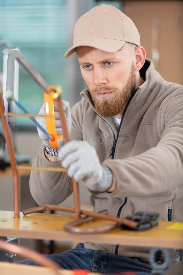 Workman Using Hacksaw on Copper Pipe Stock Photo - Image of industrial ...