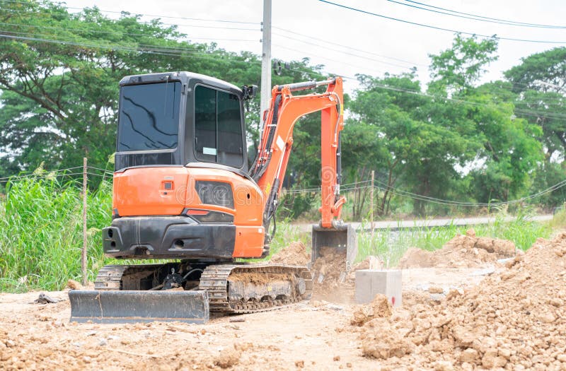 Workman Using a Mini Digger To Cover Up a Hole of Foundation Pile Stock ...