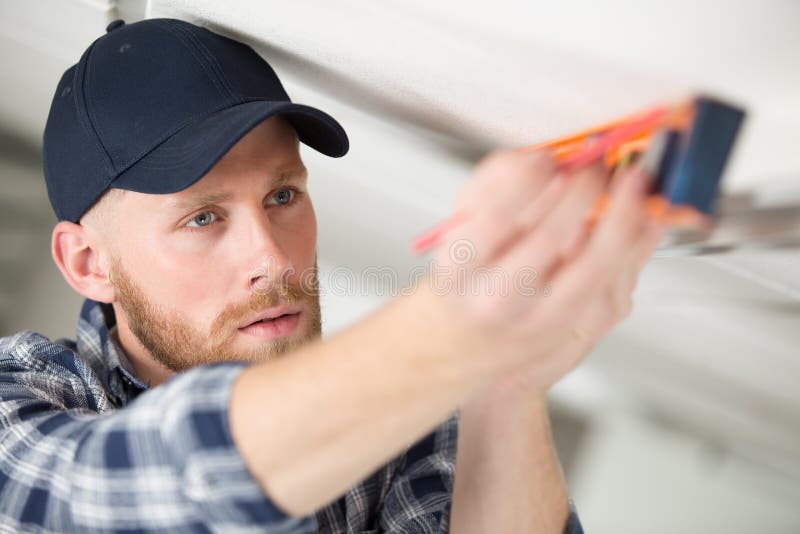 Workman using spirit level stock photo. Image of repairman - 267208806