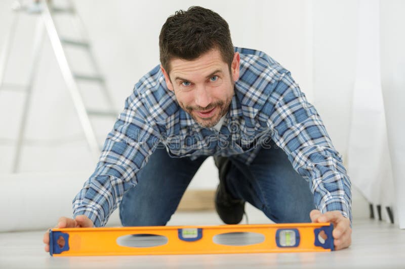Workman Using Spirit Level To Check New Flooring Stock Image - Image of occupation, interior ...