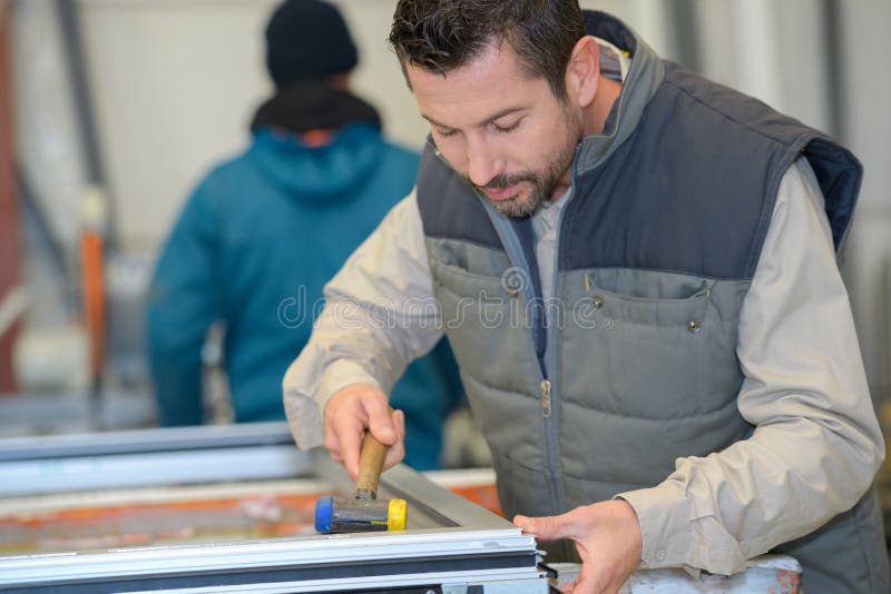 Workman Working on Window Frames at Factory Stock Photo - Image of ...
