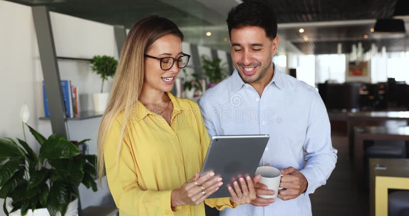 Two Workmates Using Tablet Standing in Coworking Space during Break ...