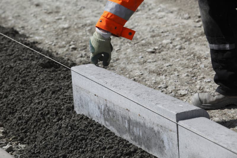Workmen laying curbstones stock photo. Image of manual - 17101902