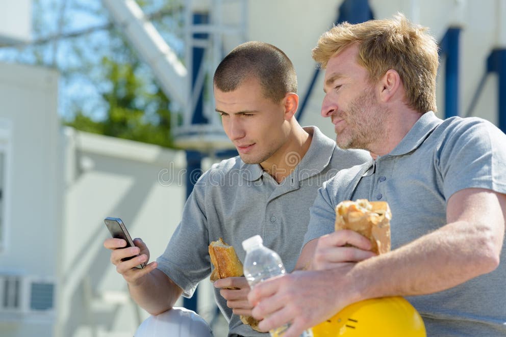 Workmen on Lunch Break Younger Man Using Smartphone Stock Photo - Image ...