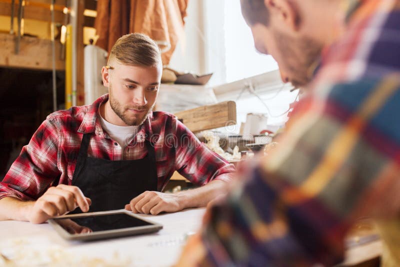 Workmen with Tablet Pc and Blueprint at Workshop Stock Photo - Image of ...