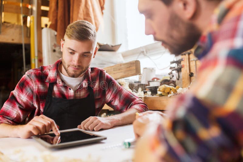 Workmen with Tablet Pc and Blueprint at Workshop Stock Photo - Image of ...