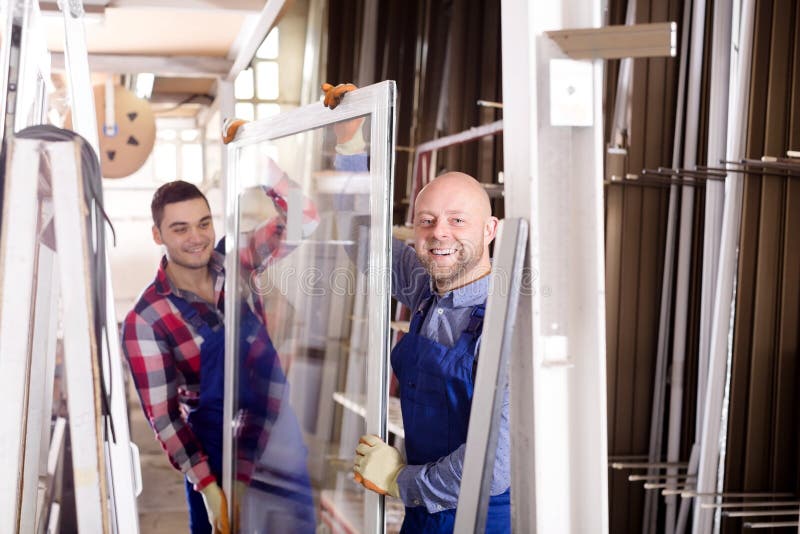 Workmen with Windows Production at Construction Site Stock Image ...