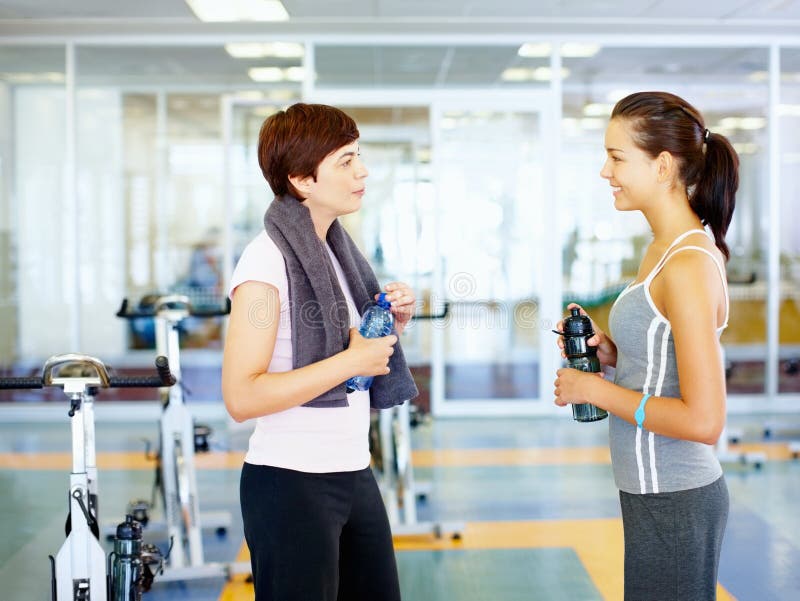 Workout Buddies. Two Girls Talking and Looking at Each Other in the Gym ...