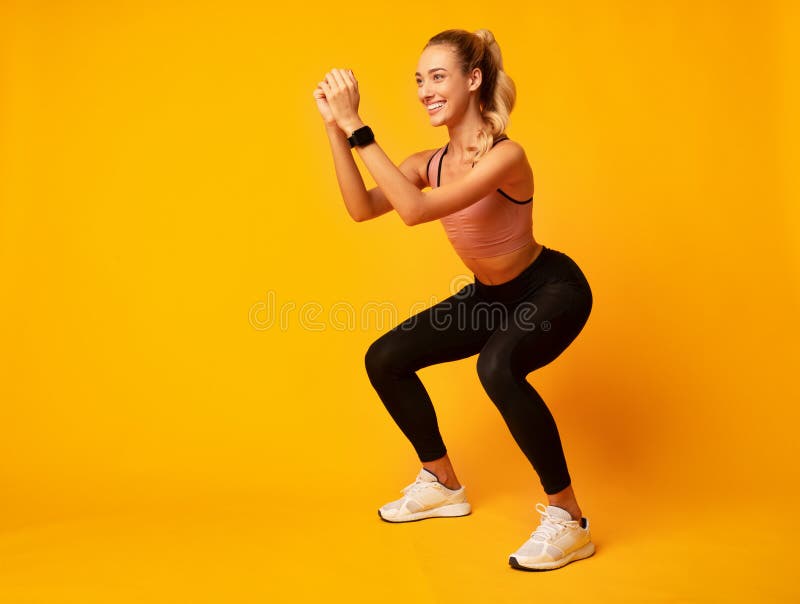 Deep Squat Of Young Beautiful Woman In Sportswear Doing Squat While ...