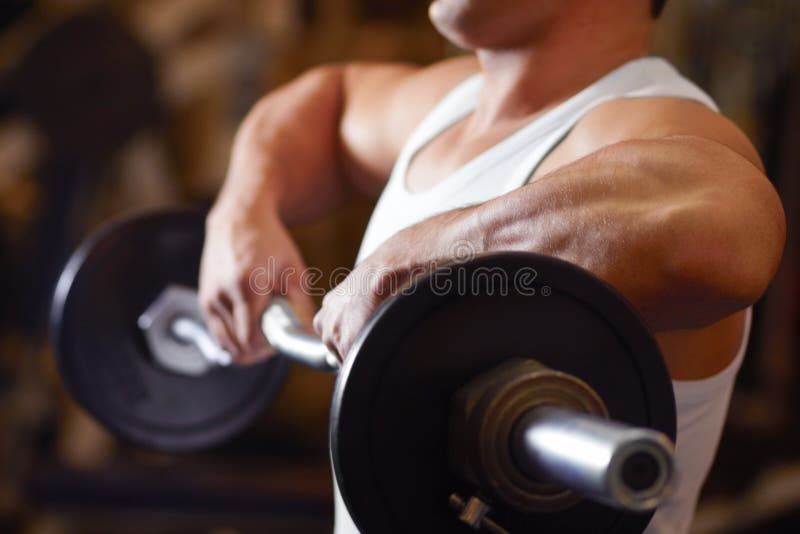 Workout with Weights. a Young Man Lifting a Dumbbell at the Gym. Stock ...