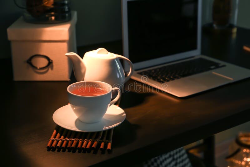 Workplace with Cup of Tea and Laptop on Table Stock Photo - Image of ...