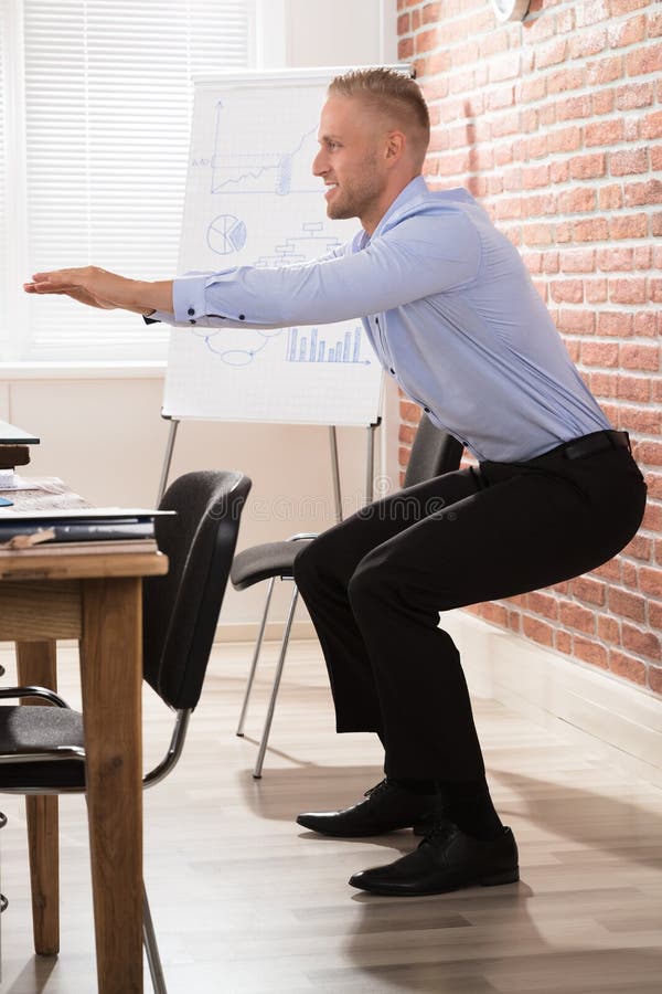 Workplace Exercise at Office Desk Stock Photo - Image of smile, human ...