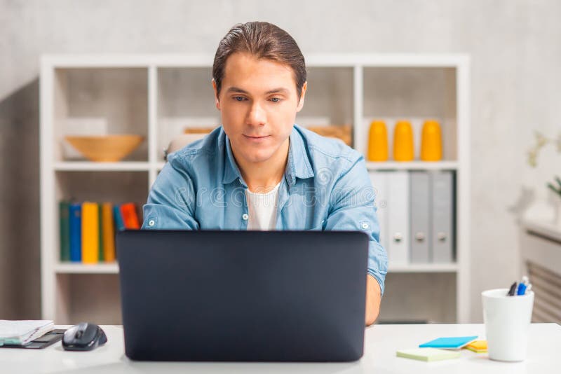Workplace of Freelance Worker at Home Office. Young Man Works Using ...