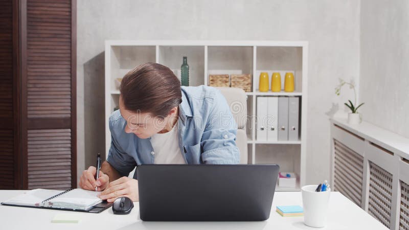 Workplace of Freelance Worker at Home Office. Young Man Works Using ...