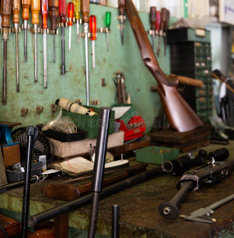 Workplace of Gunsmith in Weapons Workshop with Tools and Disassembled ...