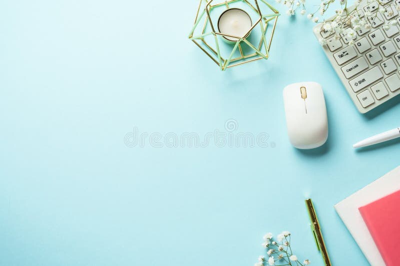 Workplace with Keyboard, Notebook, Pen and Flower on Blue Background ...