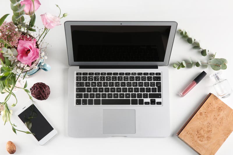 Workplace with Laptop and Beautiful Flowers on White Table Stock Image ...