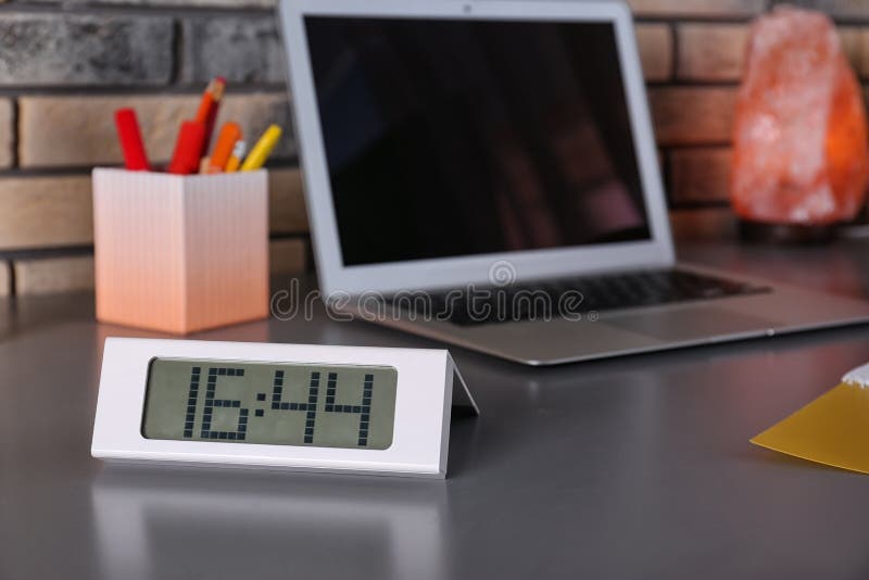 Workplace with Modern Digital Clock and Laptop in Office. Stock Image ...