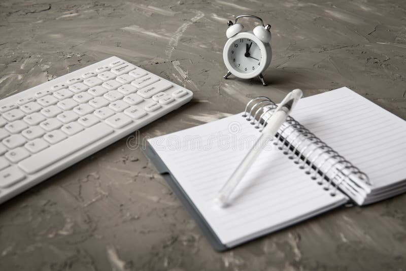 Workplace Office Accessories on a Dark Table - Keyboard and Alarm Clock ...