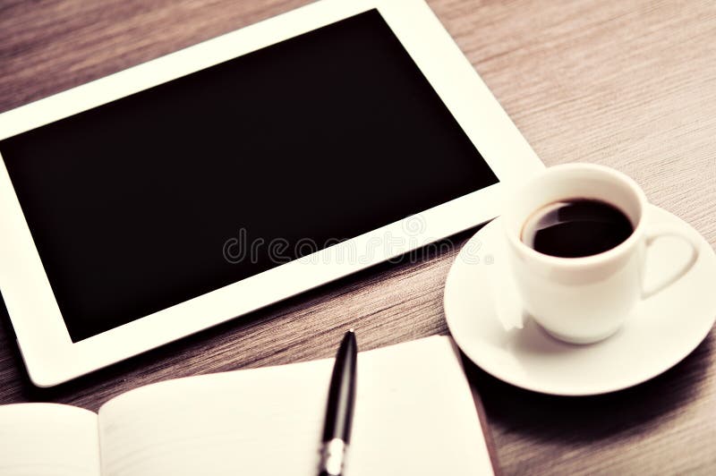 Tablet Pc and a Coffee and Notebook with Pen on the Office Desk Stock ...