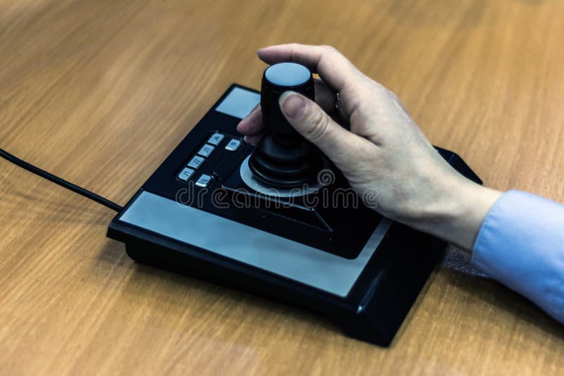 Female Hand Close-up on Joystick Control CCTV. Workplace Operator for ...