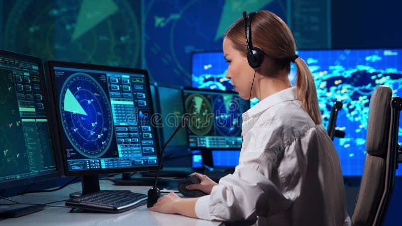 Air Traffic Controller Managing Drone Flight, Checking Data on Computer ...