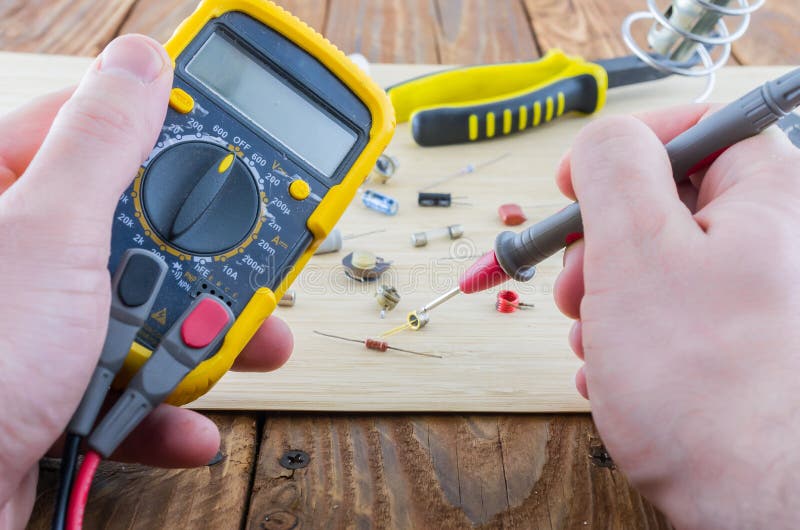 The Workplace of Serviceman. Hands Holding the Multimeter Stock Image ...