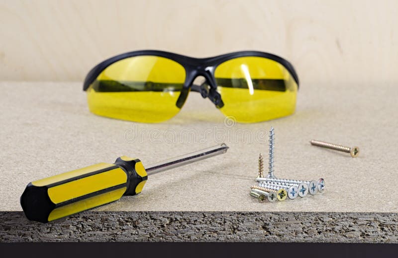 Workplace, Yellow Screwdriver and Glasses on a Wooden Table Stock Image ...