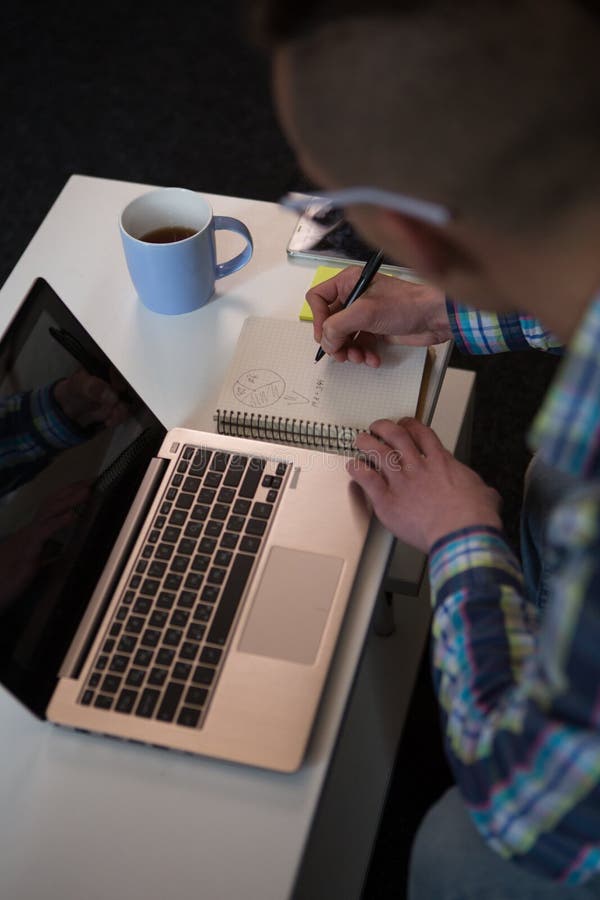 Workplace of Young Freelancer. Guy Works on Project, Using Laptop ...