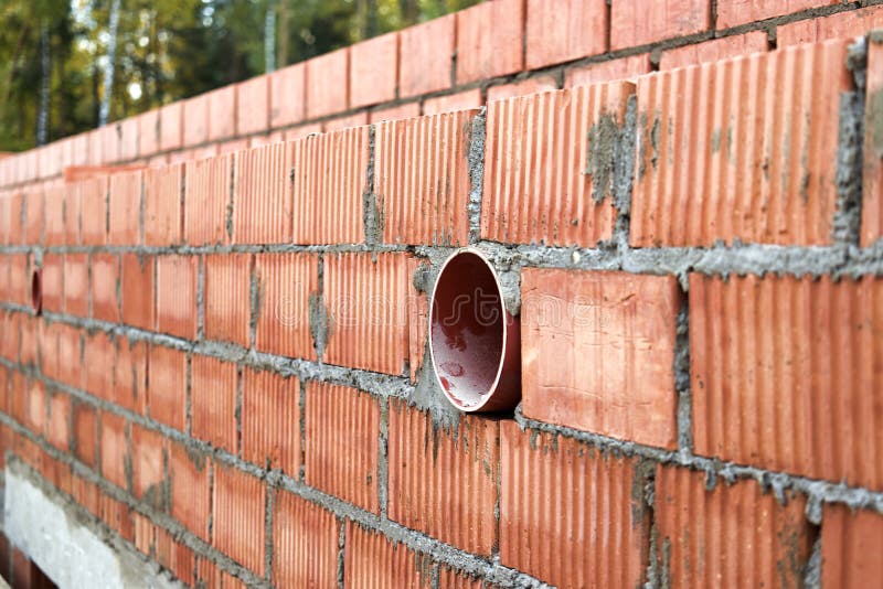 Works on the Laying of Ceramic Bricks. Red Brick Wall with Ventilation ...