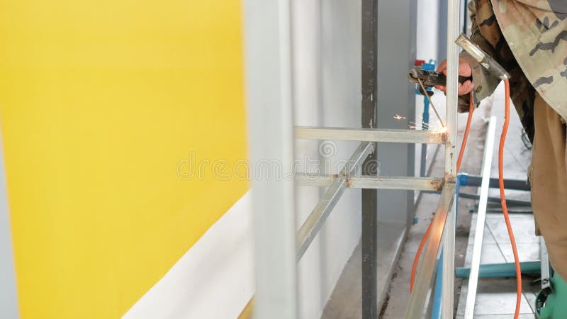 Works with Metal Using a Welding Machine, Bright Sparks, and Flash ...