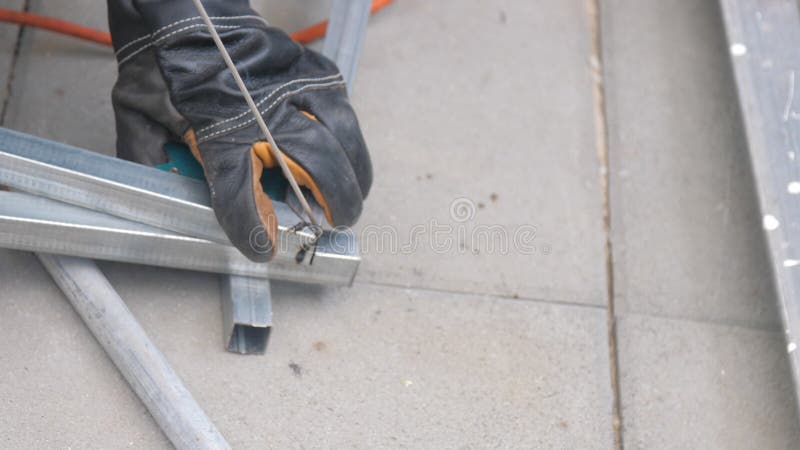 Works with Metal Using a Welding Machine, Bright Sparks, and Flash ...