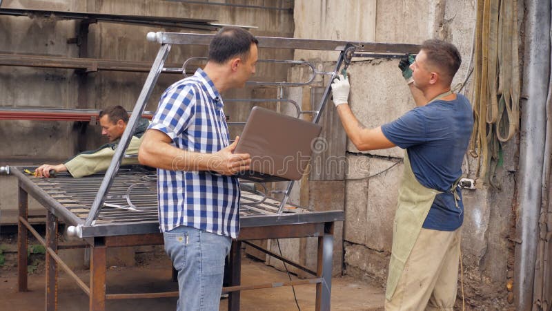 Workshop for the Production of Metal Products. an Engineer with a ...