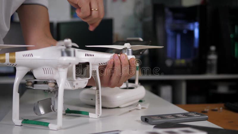 Close-up of an Engineer Repairing a Quadcopter in the Studio. Stock ...