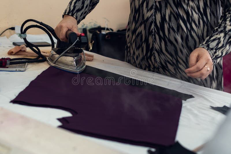 Close-up of Female Hands Steaming a Pattern with a Steam Generator in a ...