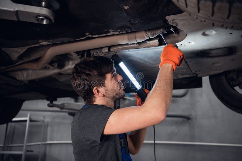 Worker Holds a Flashlight and Inspects the Car Stock Image - Image of ...