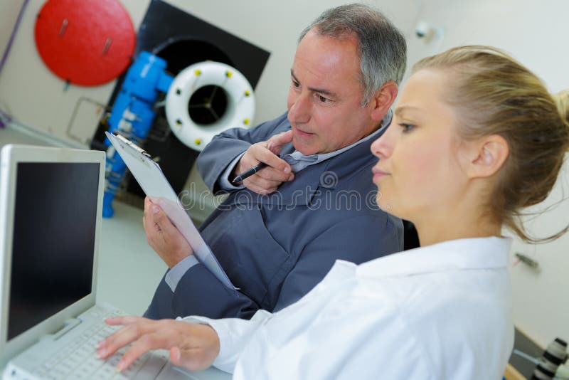 Workshop Workers Checking Laptop Results Stock Image - Image of young ...