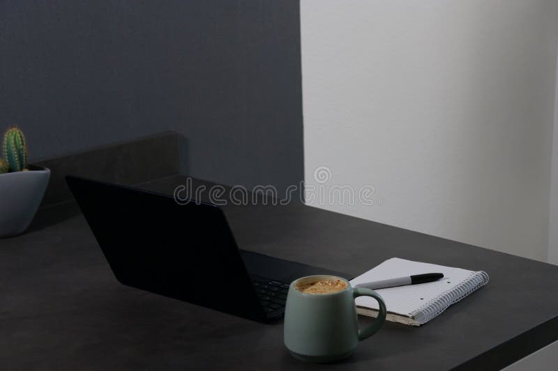 Workspace with a Black Laptop, Blank Notebook and Green Cup of Coffee ...