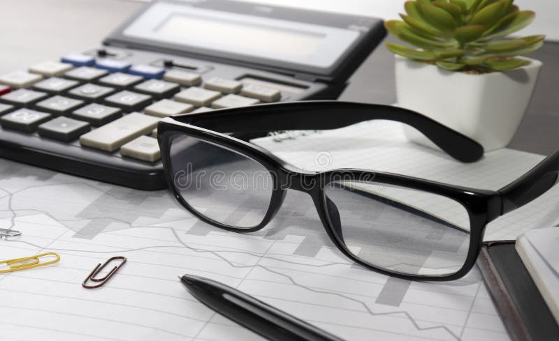 Workspace with Calculator, Pen, Glasses and Notebook. Financial Data ...