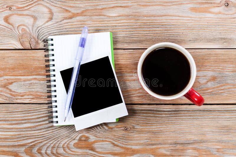 Workspace with Coffee Cup, Instant Photos, Note Paper and Notebook ...