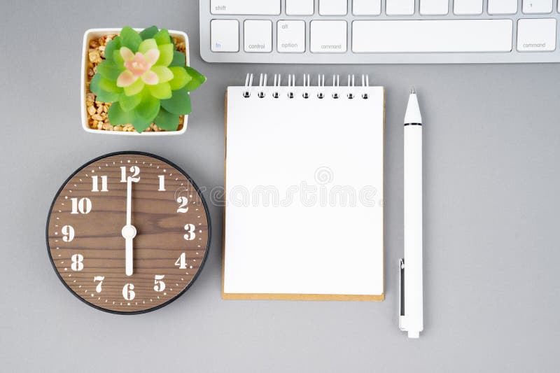 The Workspace Desk with Open Blank Notebook and Wooden Clock with ...