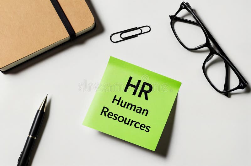 A Workspace with HR Related Items Including a Notebook, Glasses, a ...