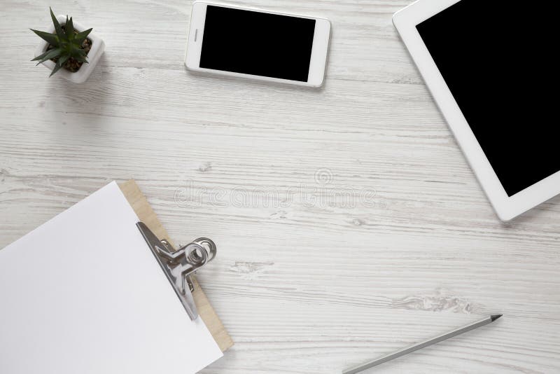 Workspace with Smartphone, Tablet, Clipboard and Pencil, Overhead. Top ...