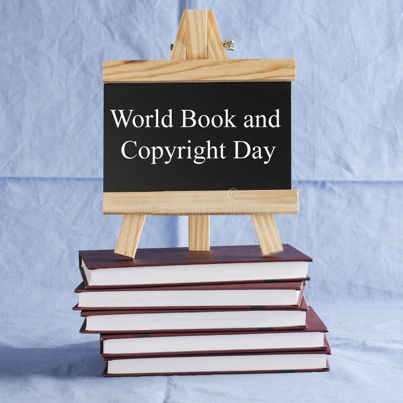 World Book and Copyright Day Written on Black Board on Stack of Books ...